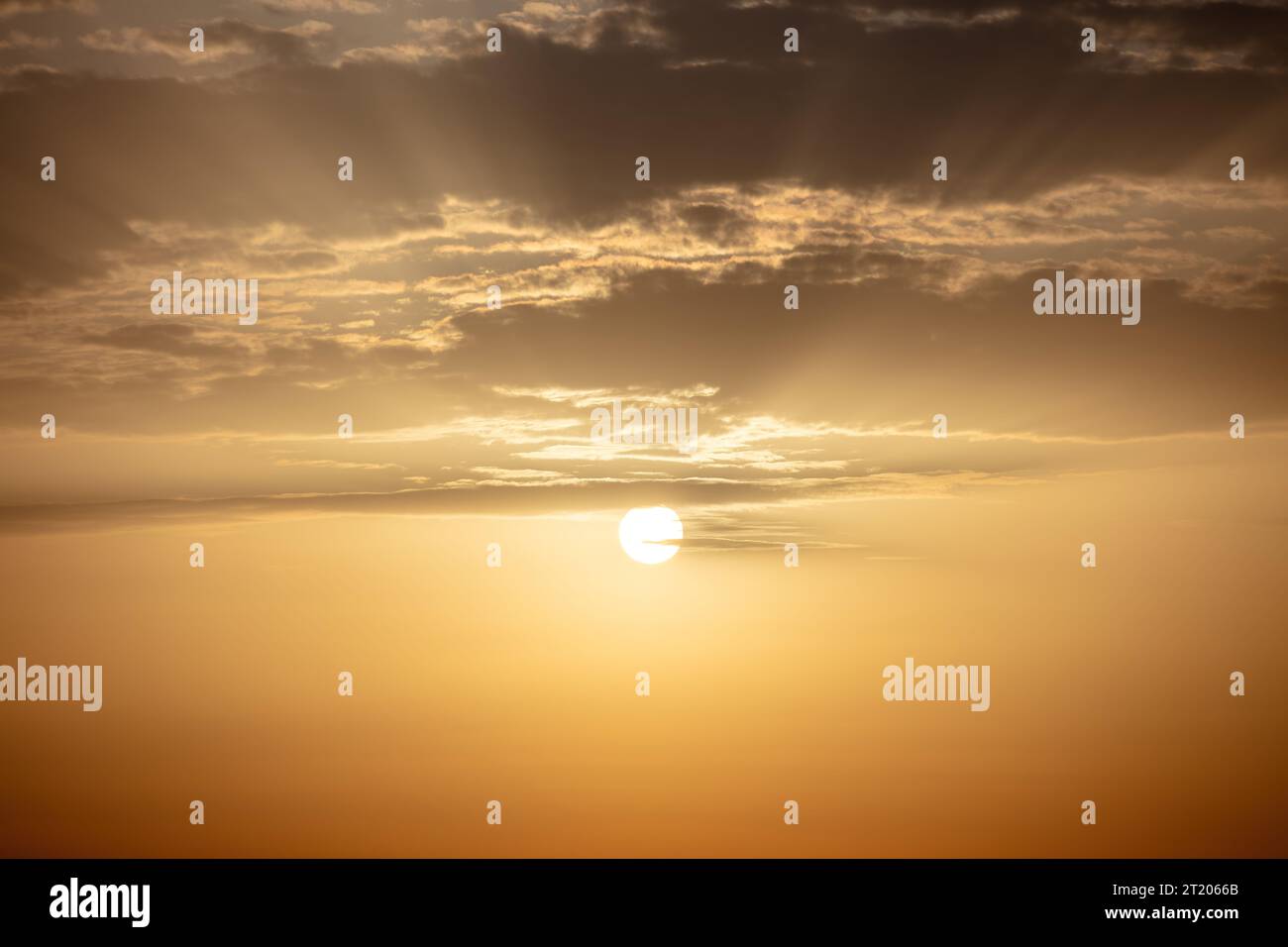 Sunset at cloudscape background. Sunbeam colors the sky, golden sun ...