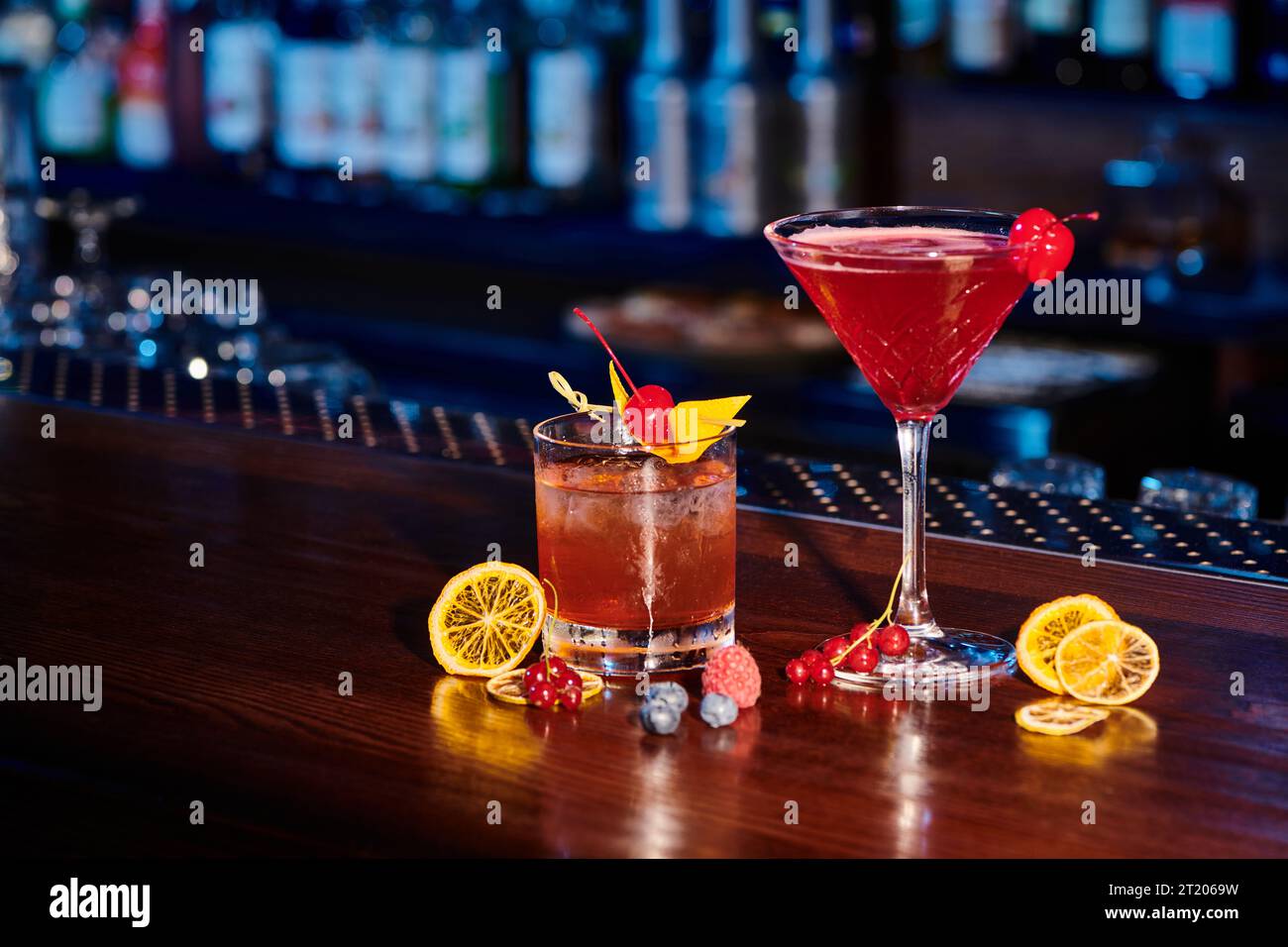 tropical negroni and cosmopolitan cocktails garnished with cocktail ...