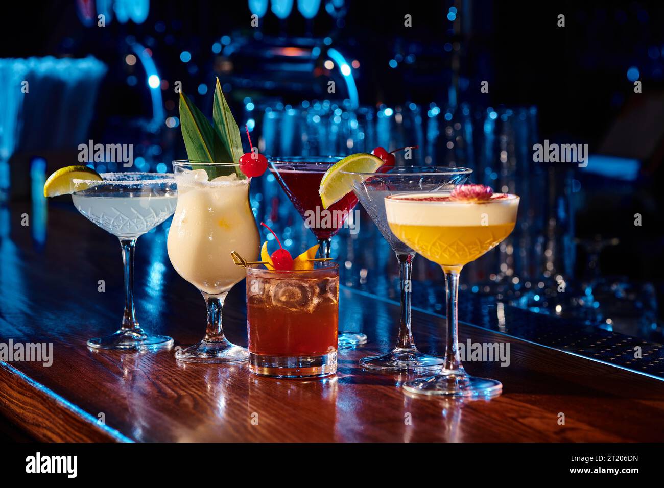 six different topical and elegant cocktails with bar cabinet on ...
