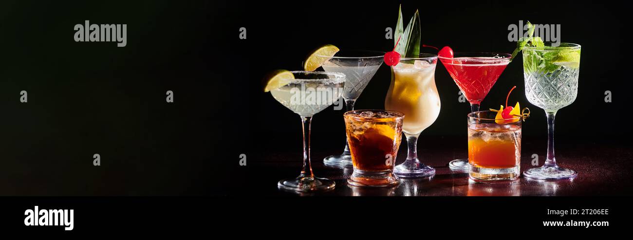 set of zesty cocktails with fresh decorations on black background ...