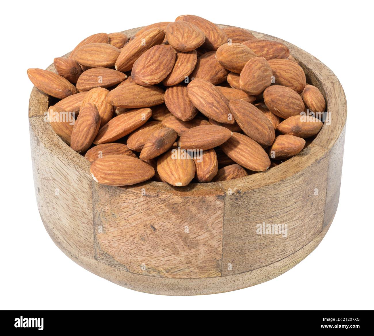 Almond kernels in a round wooden plate on a white isolated background ...