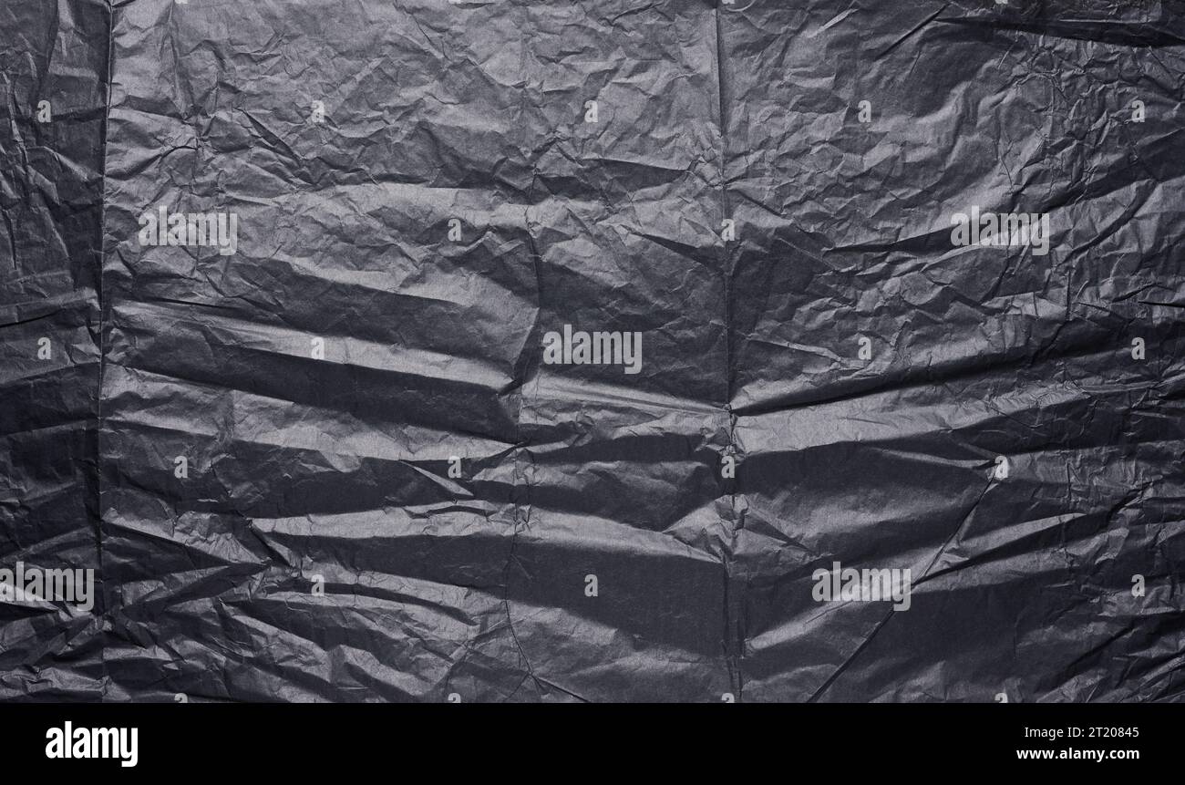Crumpled sheet of black parchment paper, abstract background Stock ...