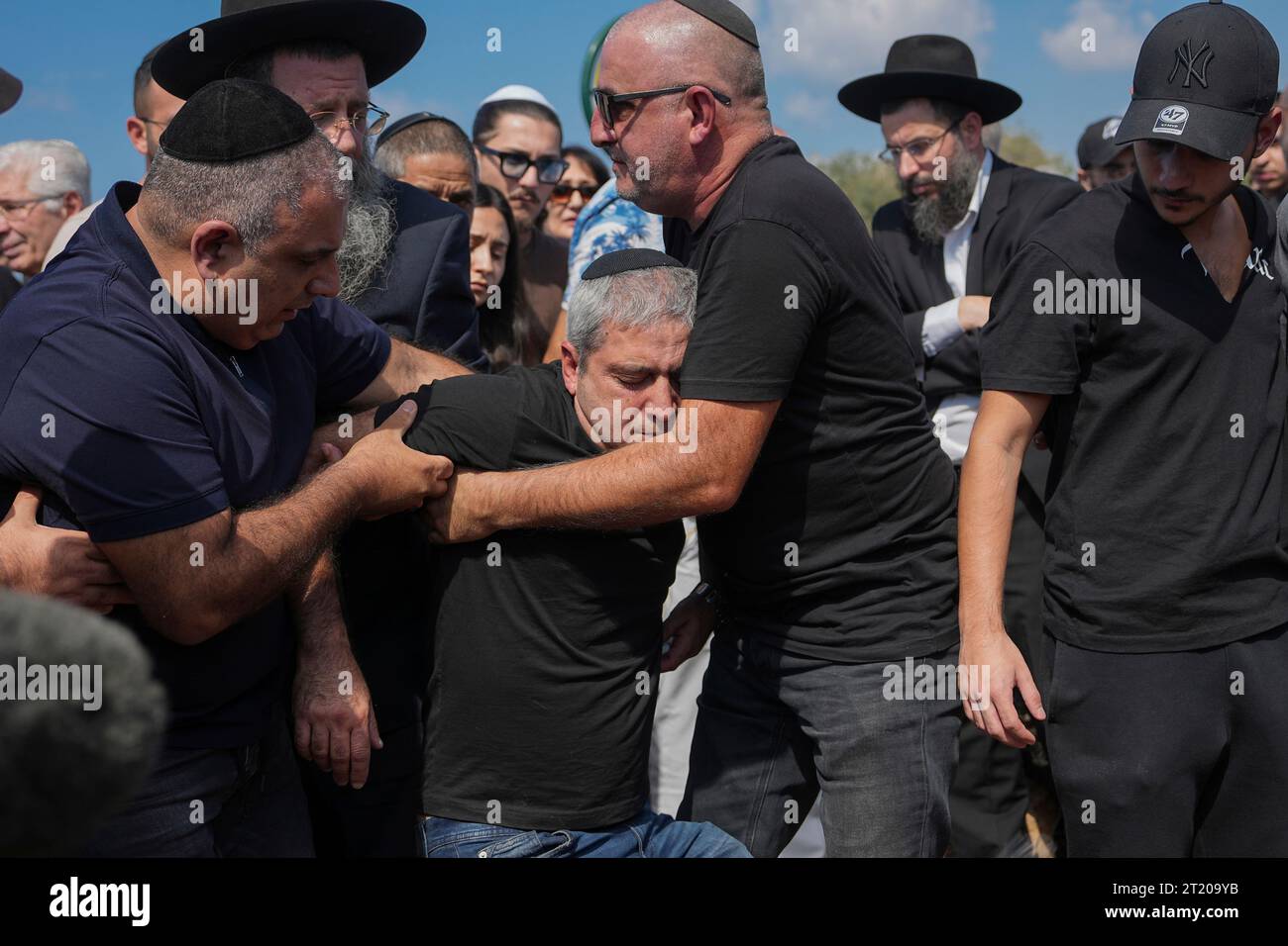 Father of Naor Hassidim grieves over his son's grave, during his ...