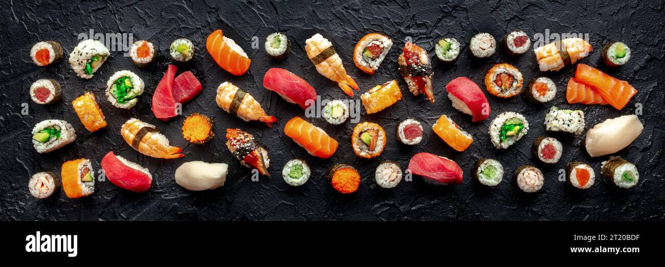 Sushi panorama. An assortment of rolls, maki, nigiri etc, overhead flat ...