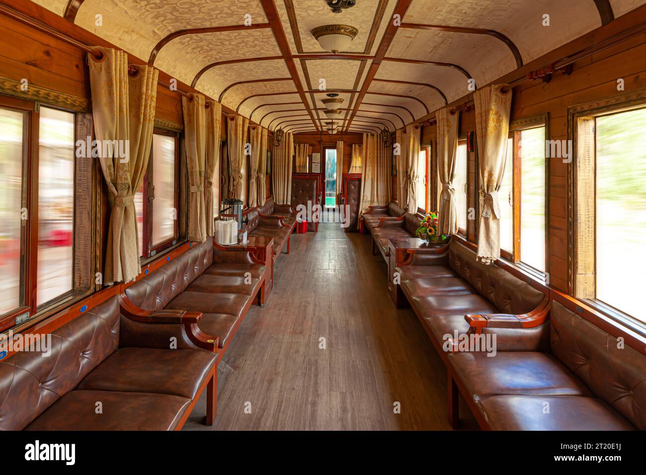Interior of vintage old train carriage with leather chair, wooden floor ...