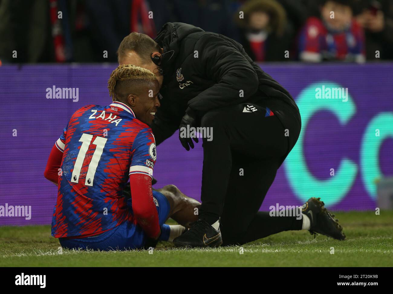 Wilfried Zaha of Crystal Palace goes down injured and is substituted ...