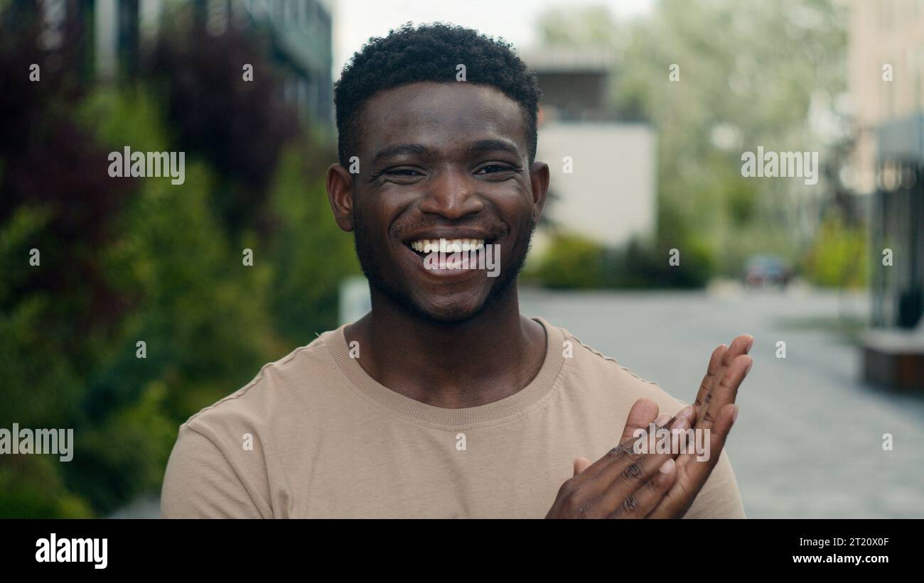 Happy smiling African American man smile applauding looking at camera ...