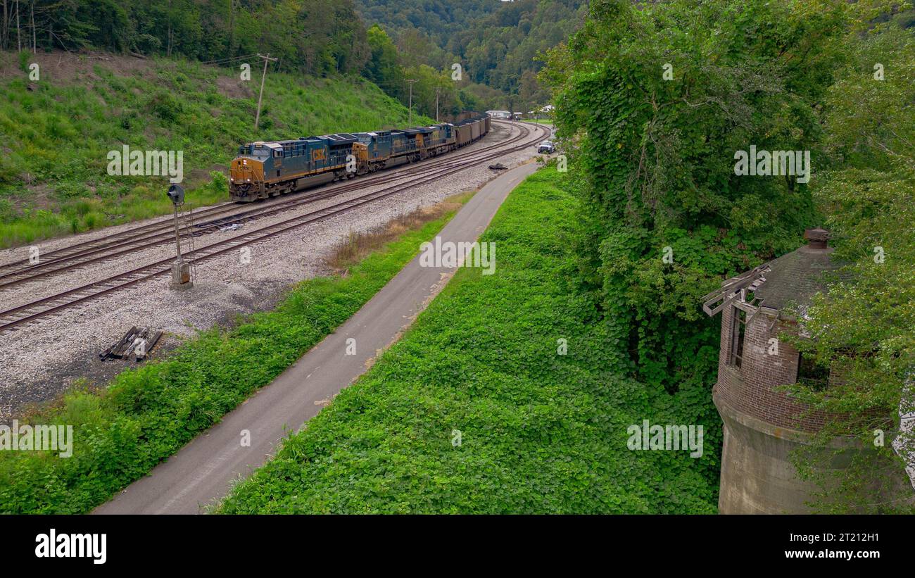 A freight train is captured in motion on a set of railway tracks that ...
