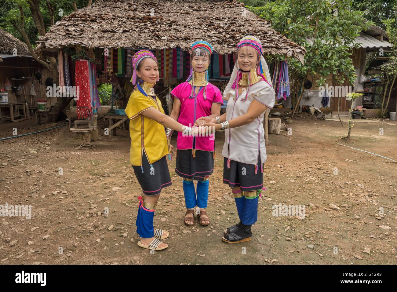 three long-necked Karen women with brass neck rings showing Karen dance ...