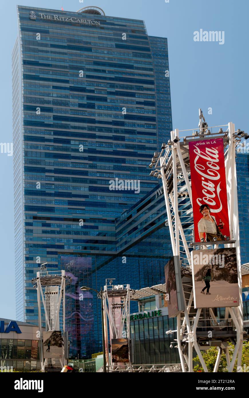 A red Coca-Cola vending poster situated outside of a modern city ...