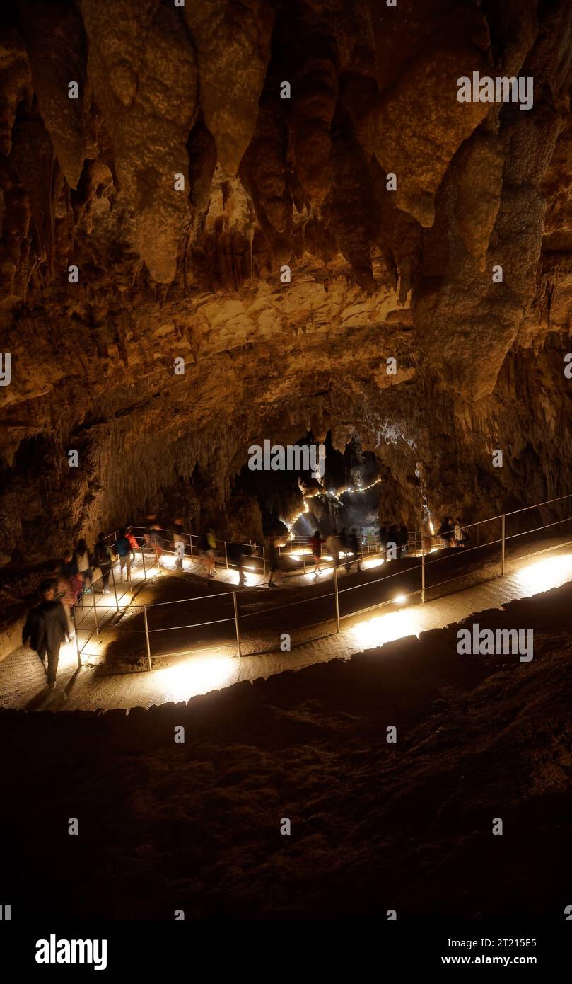 A breathtaking entrance to a natural limestone cave, situated by a ...