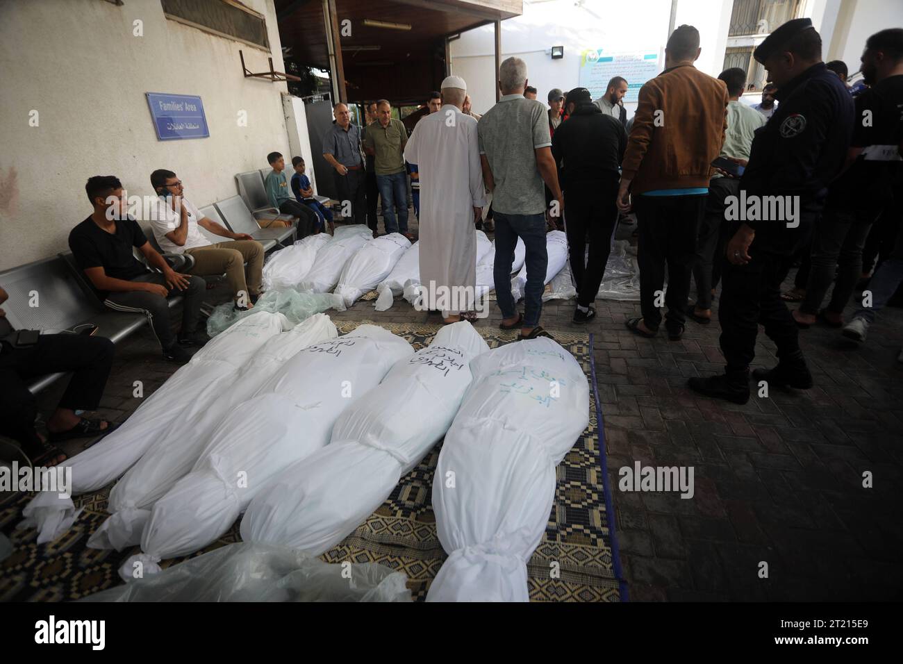 Rafah, Gaza. 15th Oct, 2023. Palestinian relatives stand with bodies ...