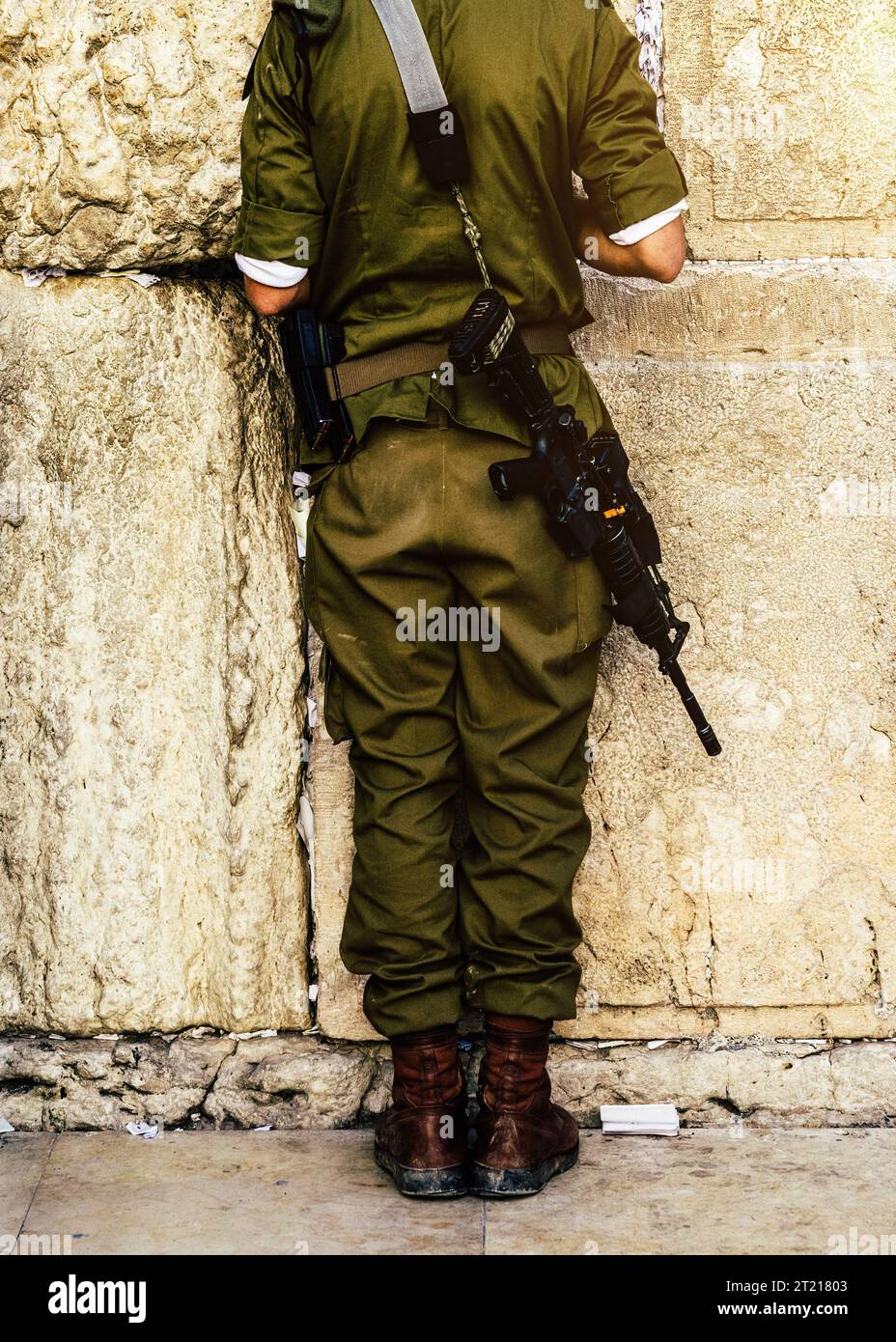 Back of unidentifiable Israeli solder praying on Wailing Western Wall ...
