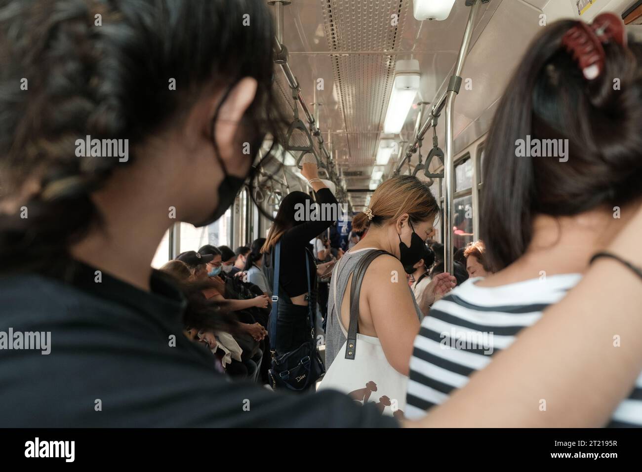 Manila, Philippines: Filipino commuters inside a cabin in a moving LRT ...
