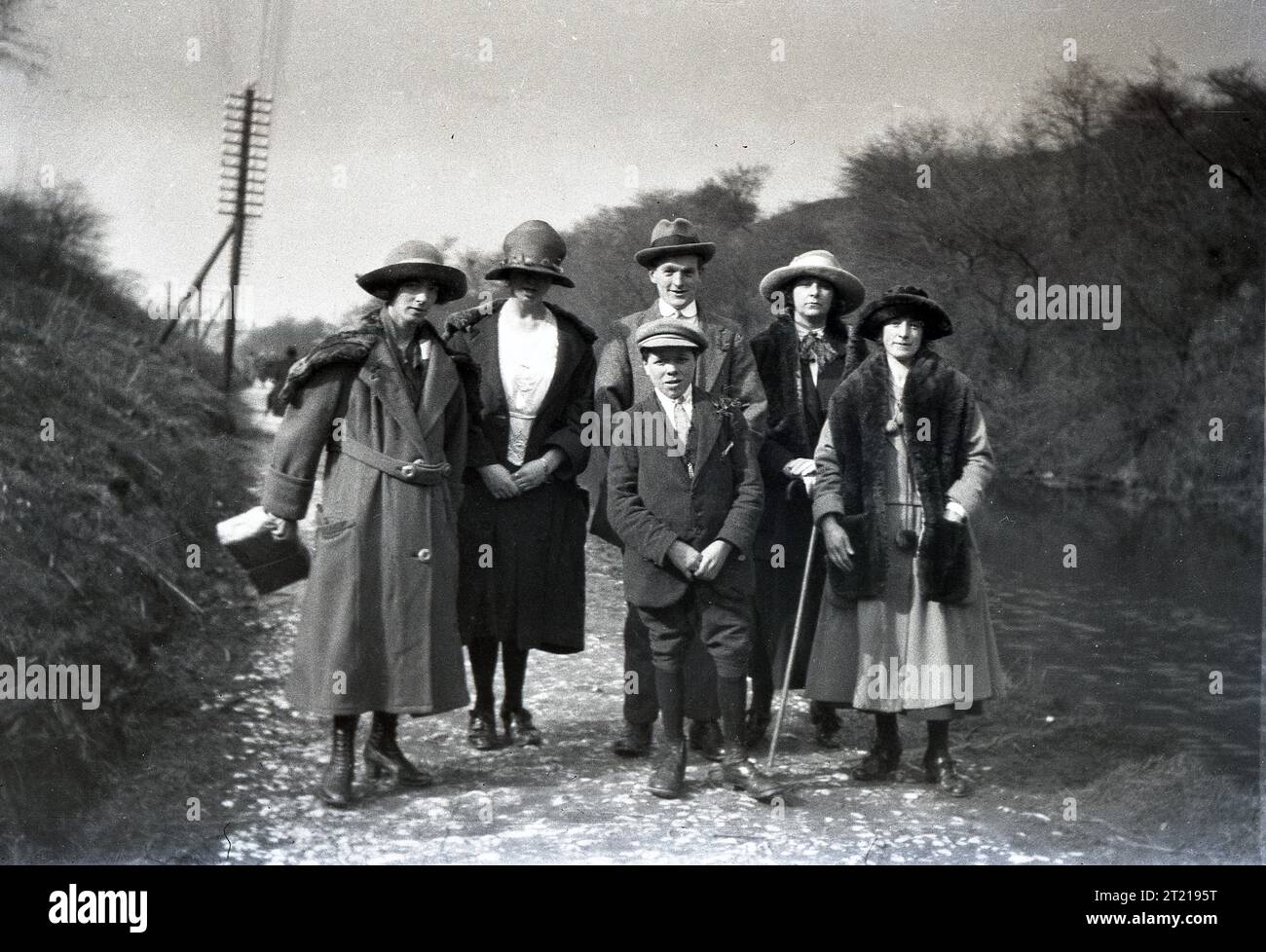 circa 1920s, historical, a family int he clothes of the era stand on a ...