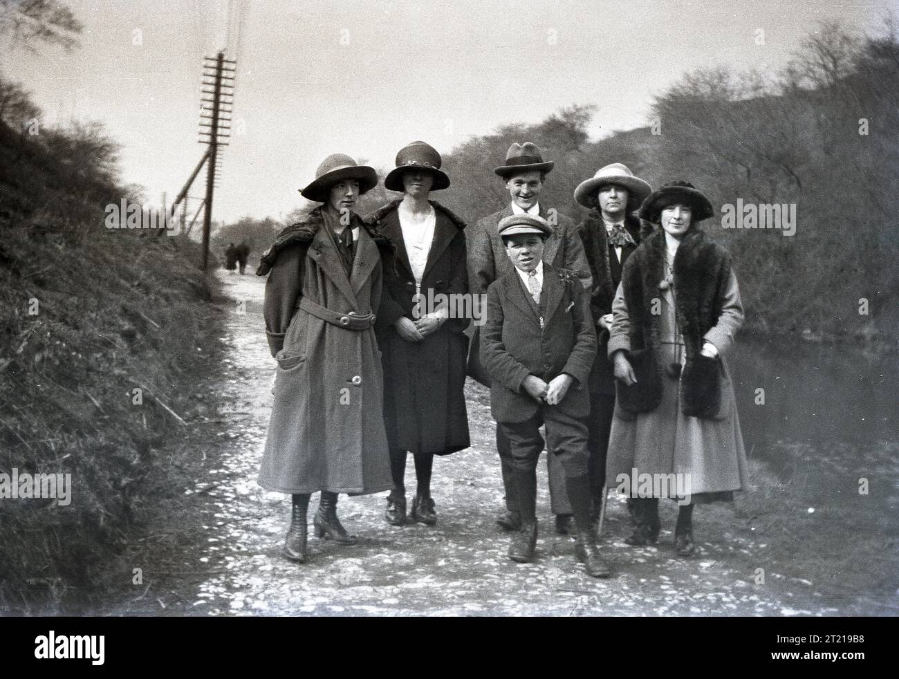 circa 1920s, historical, a family int he clothes of the era stand on a ...