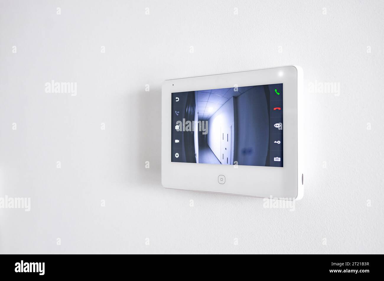 A white video intercom screen on a white apartment wall Stock Photo - Alamy