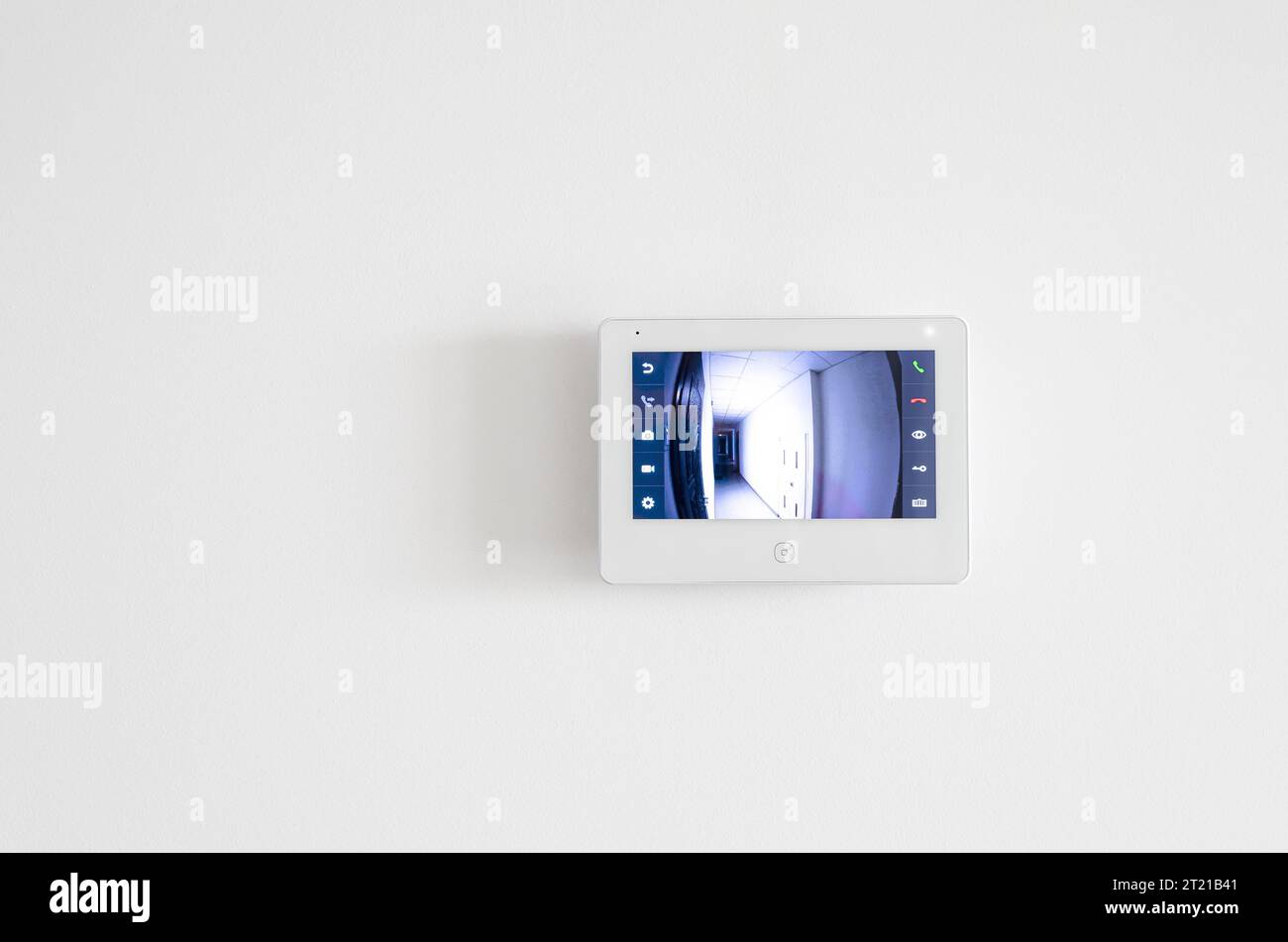 A white video intercom screen on a white apartment wall Stock Photo - Alamy