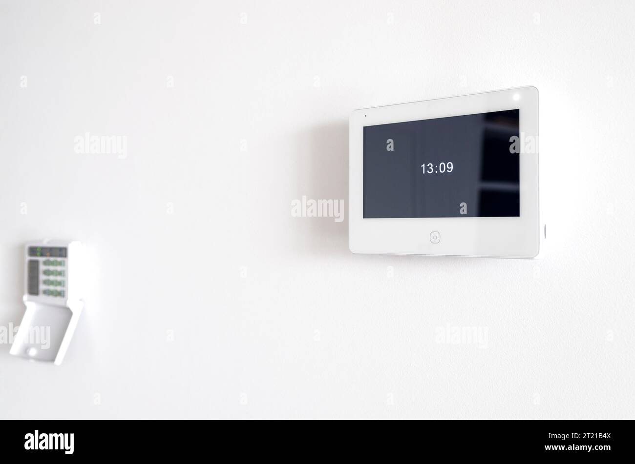 A white video intercom screen on a white apartment wall Stock Photo - Alamy