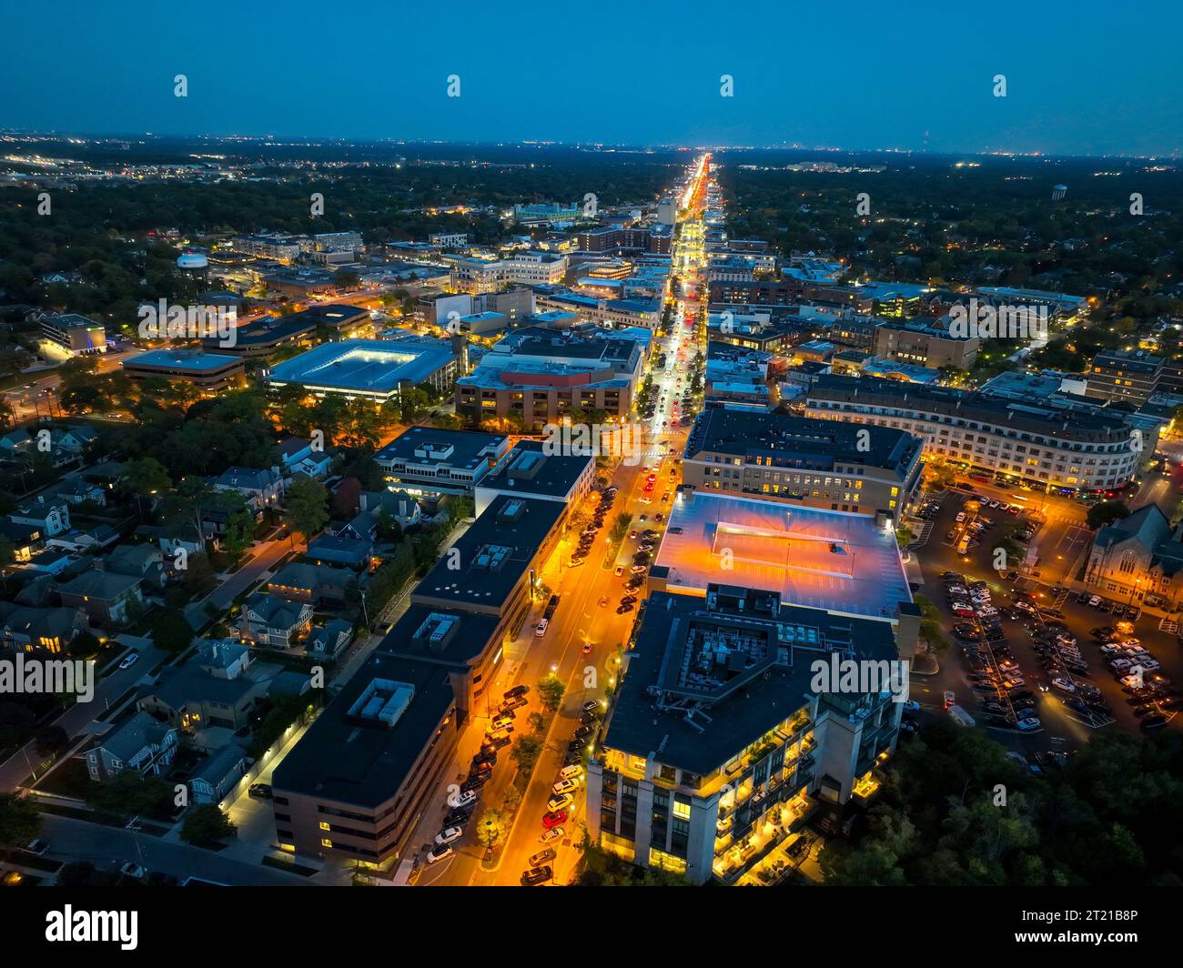 A vibrant city street view at night with illuminated buildings in ...
