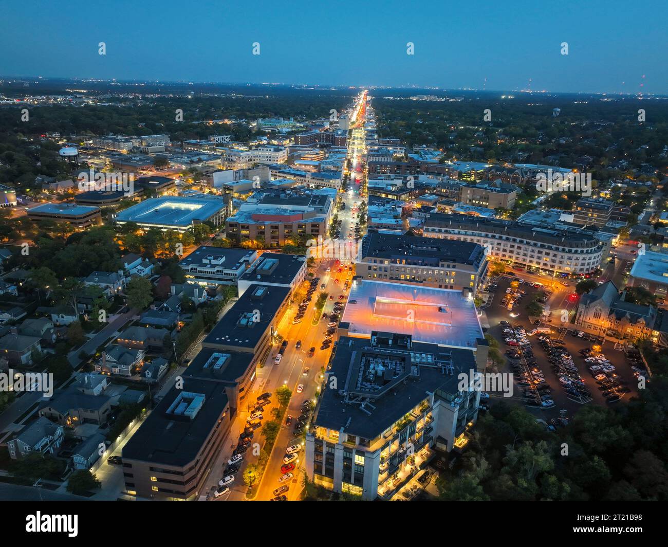 A vibrant city street view at night with illuminated buildings in ...