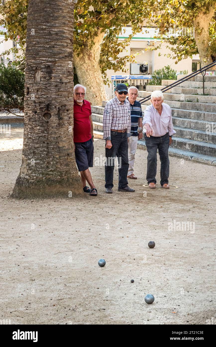 Older men playing Petanque in a town square Stock Photo - Alamy