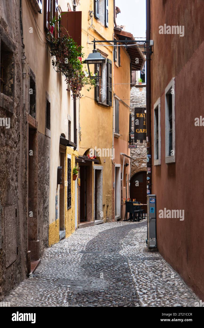 This image depicts a quaint, old-fashioned street in a European city ...