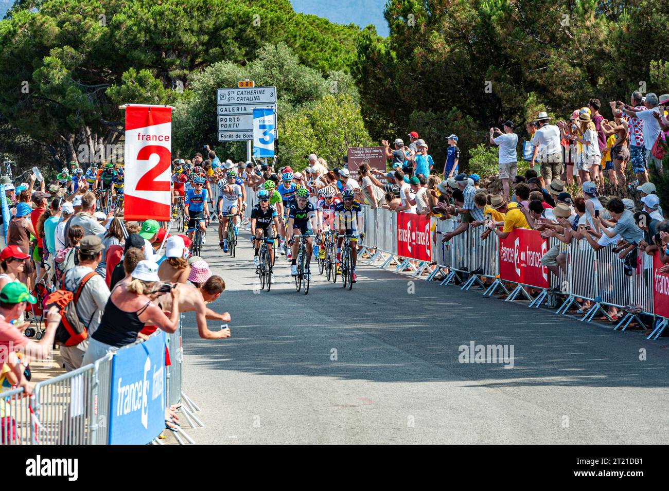 Spectators line the road to watch the cyclists go past during the first ...
