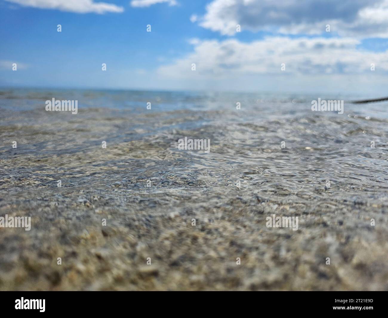 A coastal beach setting featuring shallow, murky ocean waters Stock ...