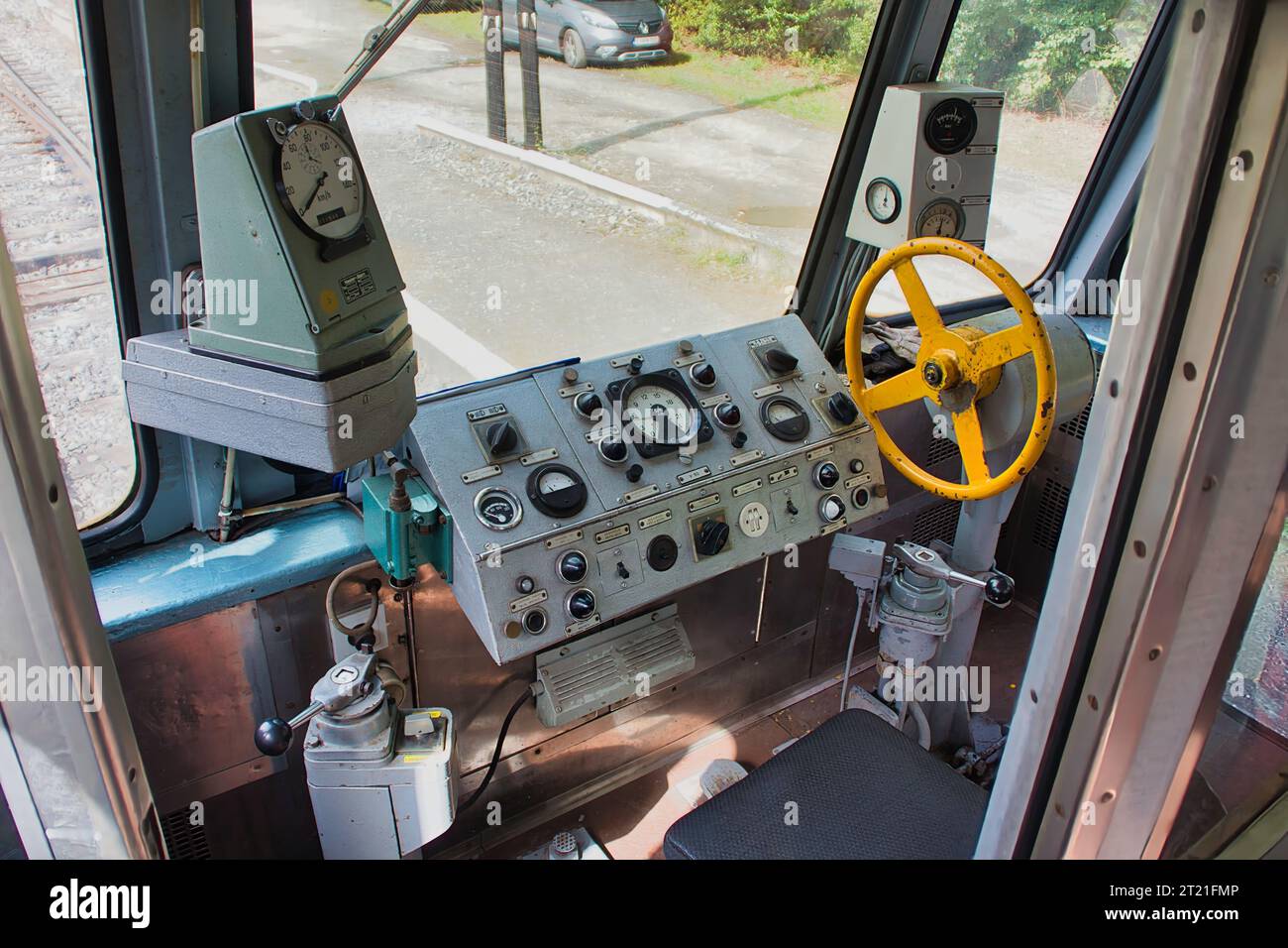 The interior of a train car, with various buttons on and a large window ...