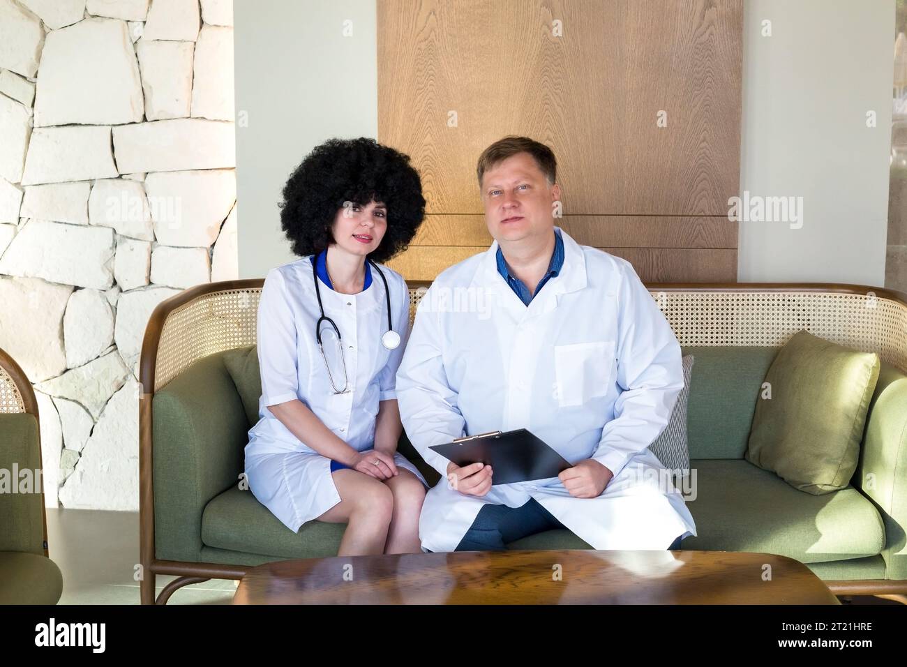 A couple of doctors talking in the hall, discussing the diagnosis of a ...