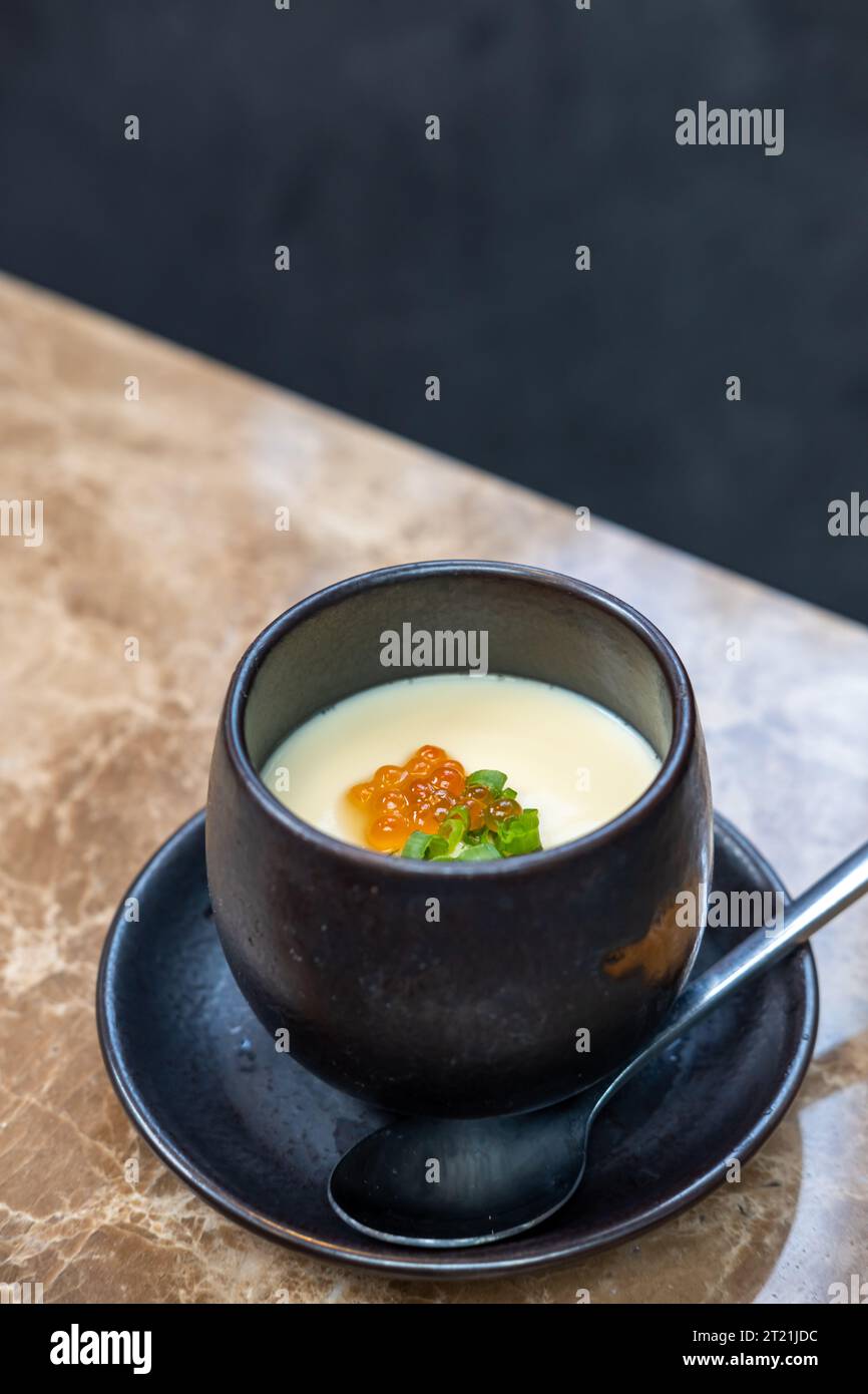 Steamed eggs with salmon roe, served in a black bowl Stock Photo - Alamy