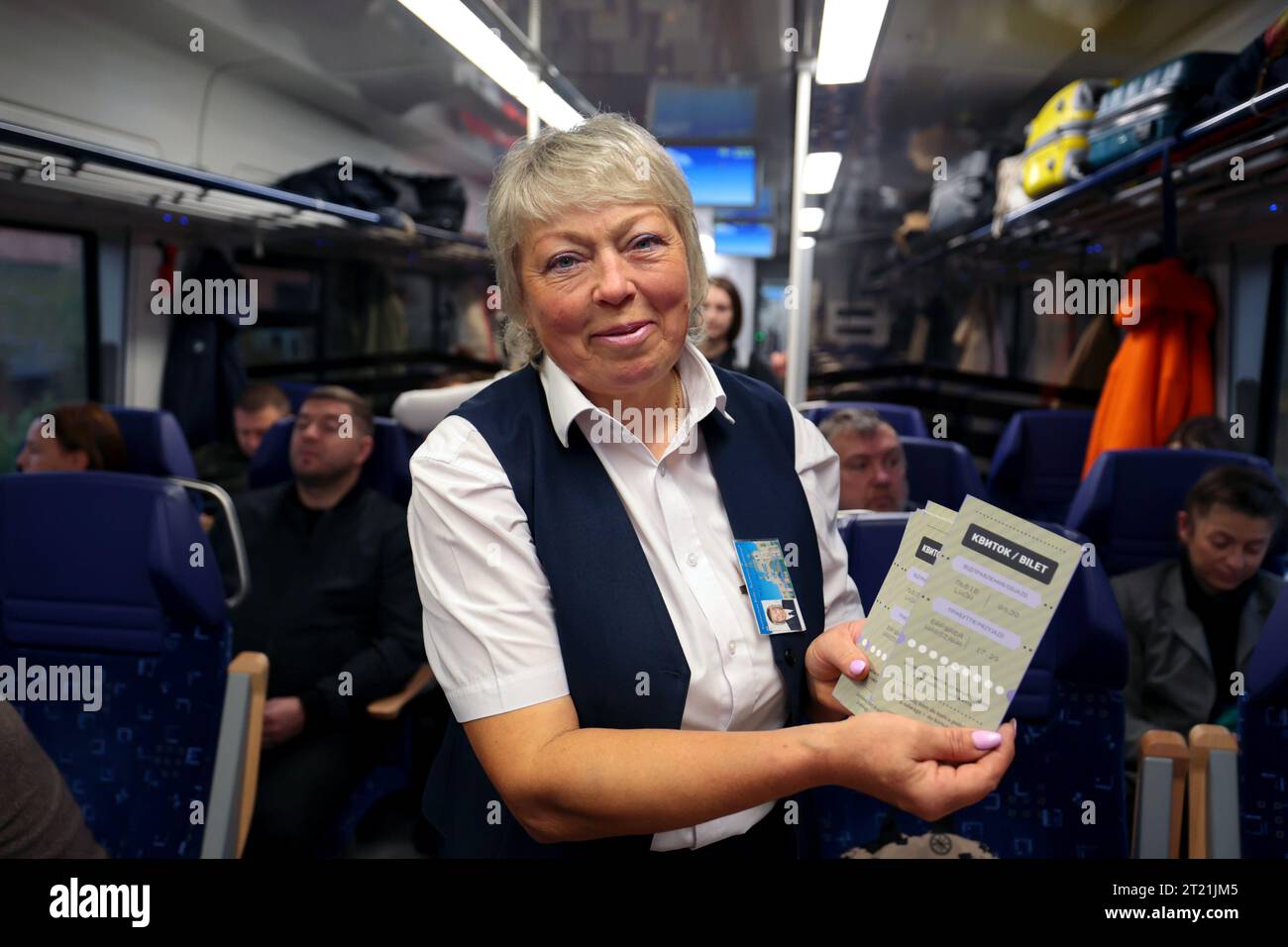 LVIV, UKRAINE - OCTOBER 15, 2023 - A train guard shows the Passenger of ...