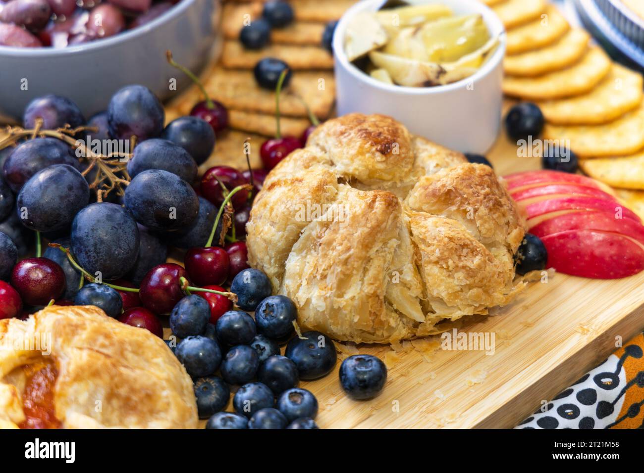 snacks on the table, grapes, olives, danish pastry, biscuits, atcha ...