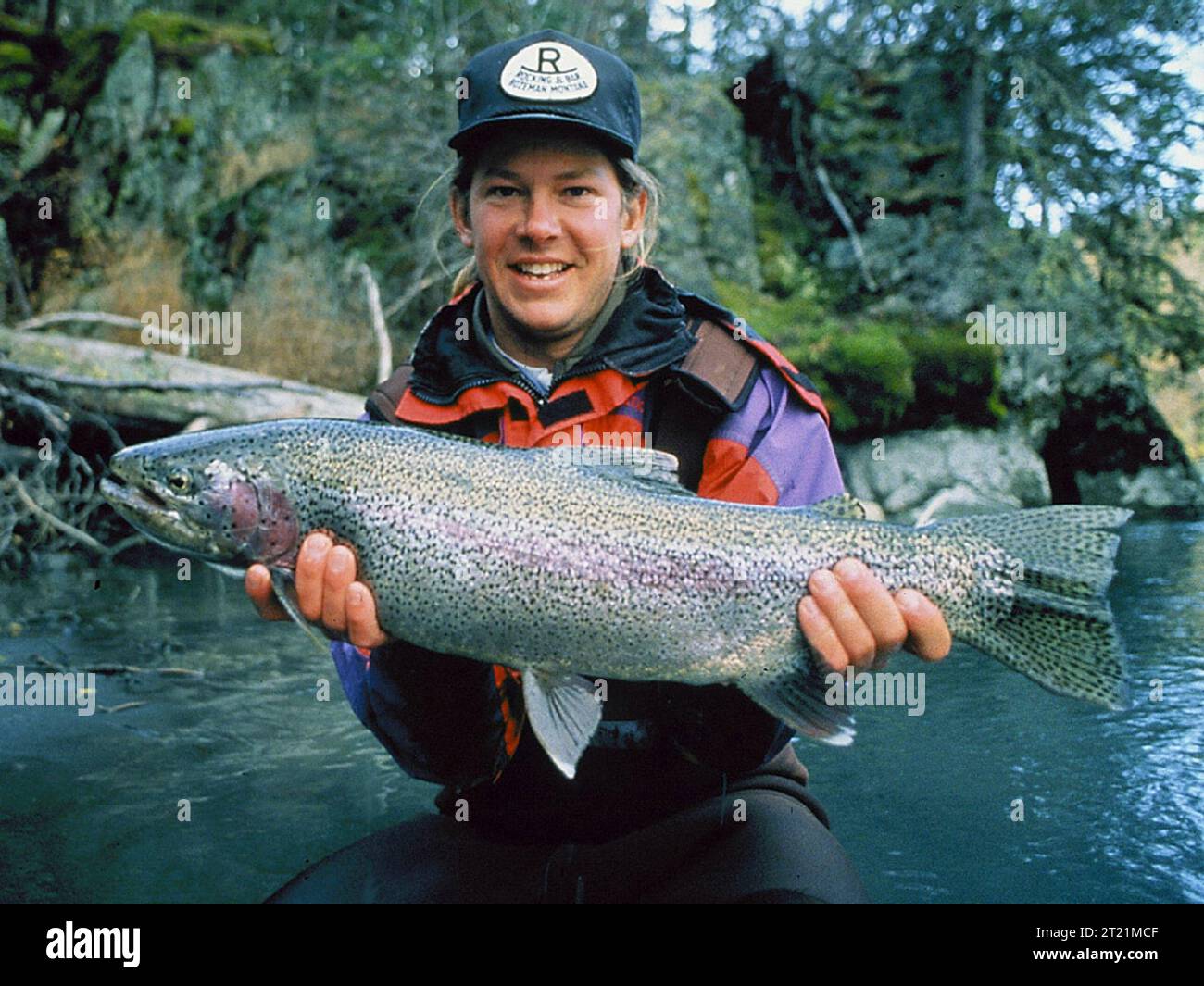Brad Benter holds a rainbow trout caught in the Kenai River canyon for ...
