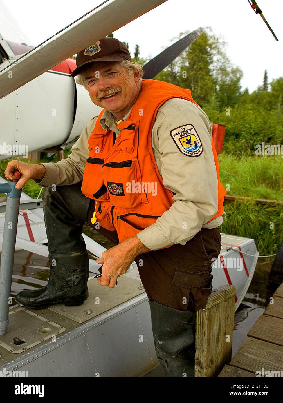 Fish and Wildlife Service employee poses with plane before a flight ...