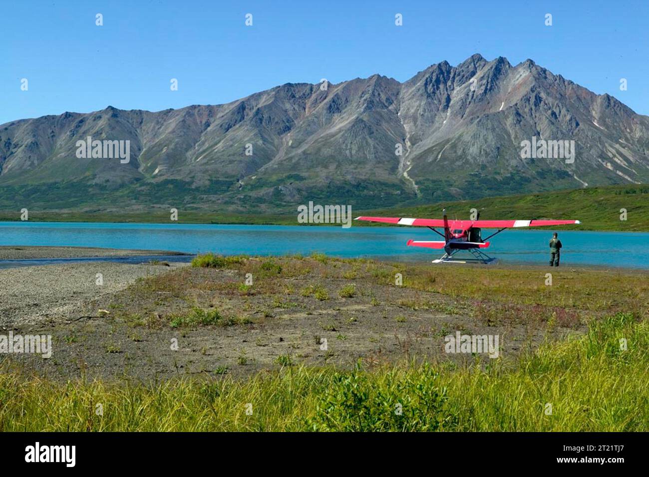 A small floatplane rests on the surface of a calm lake within Togiak ...