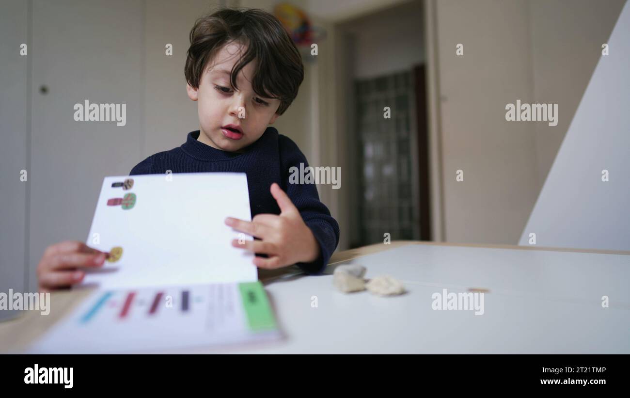 Child picking up book hi-res stock photography and images - Alamy