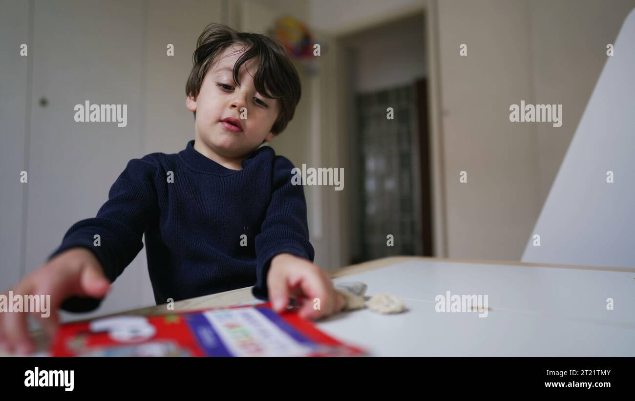 Child picking up book hi-res stock photography and images - Alamy