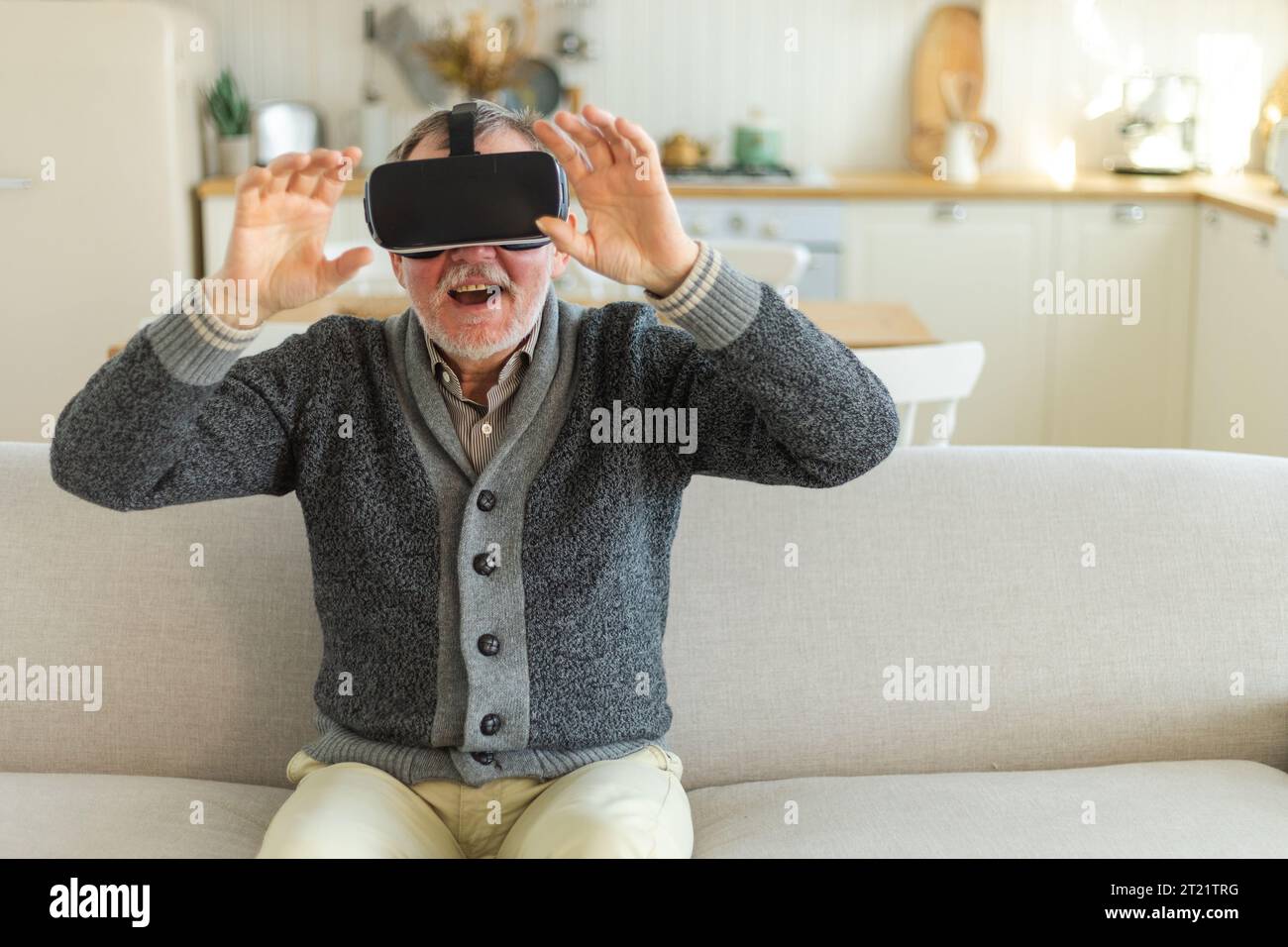 Excited mature senior man wearing using virtual reality metaverse VR ...