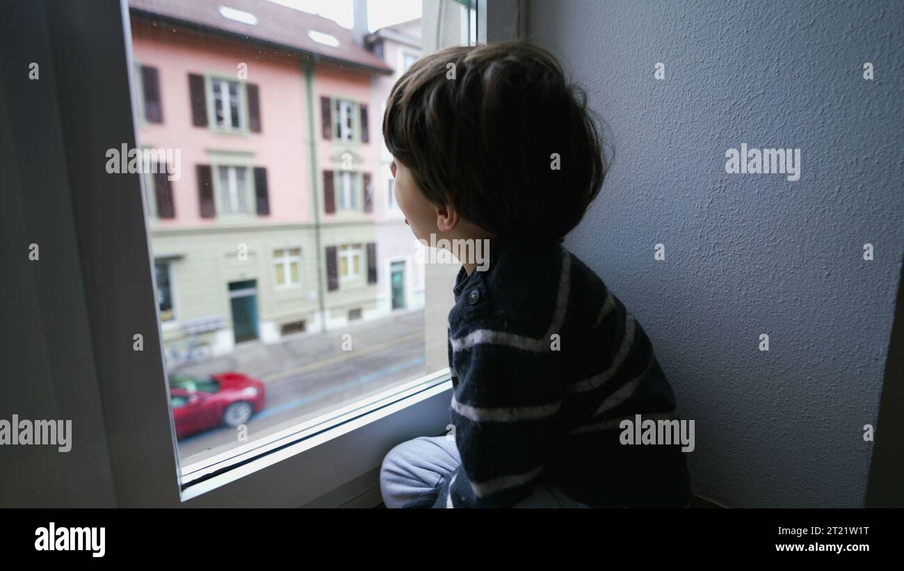 Child breathes into home window creating condensation, bored kid locked ...