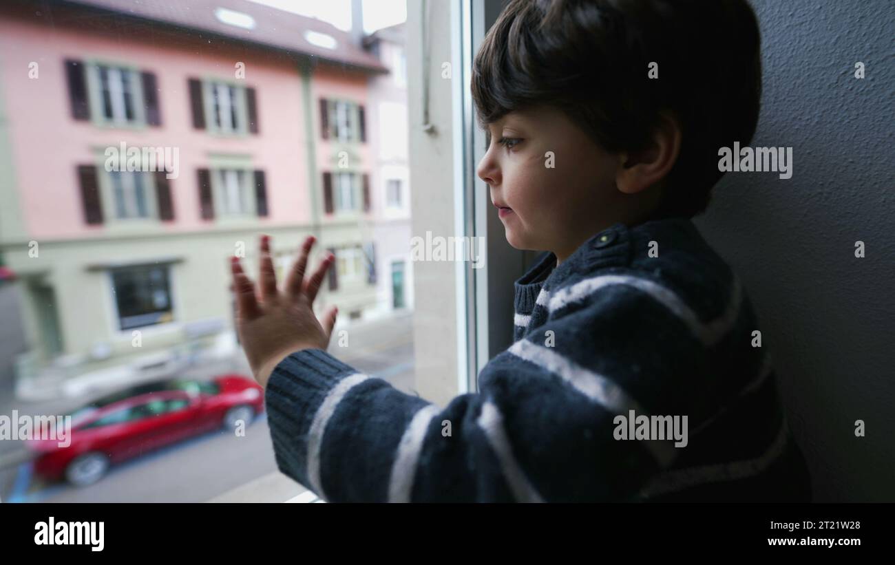 Child breathes into home window creating condensation, bored kid locked ...
