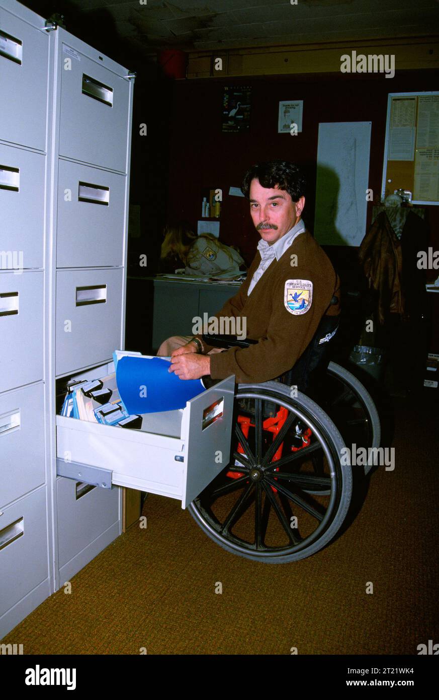 Fish and Wildlife Service office personnel in wheelchair. Vertical ...