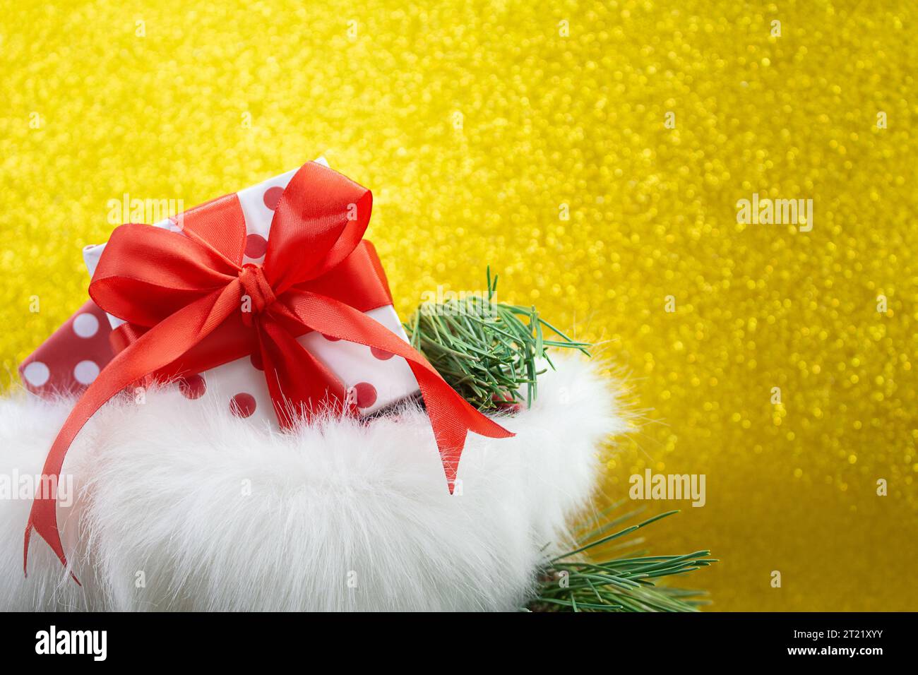 Open fluffy bag with gift box with polka dot and red bow and fir ...