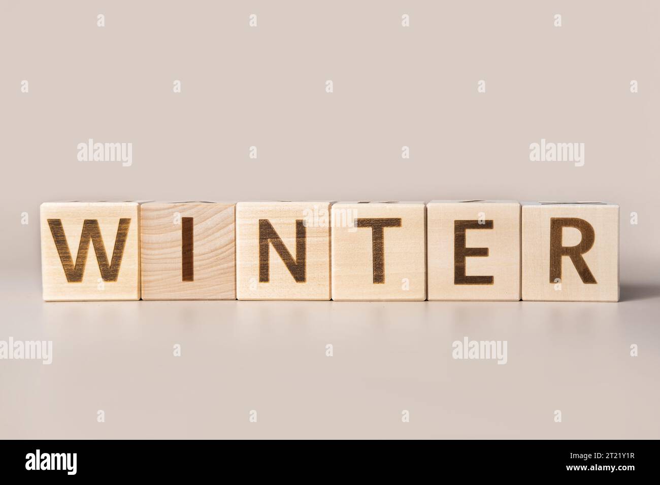 The Word Winter on wooden cubes on a beige neutral studio background ...