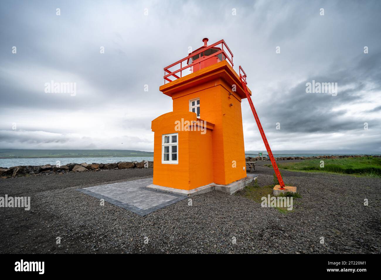 Svalbarðseyri lighthouse, a small brightly colored orange light house ...