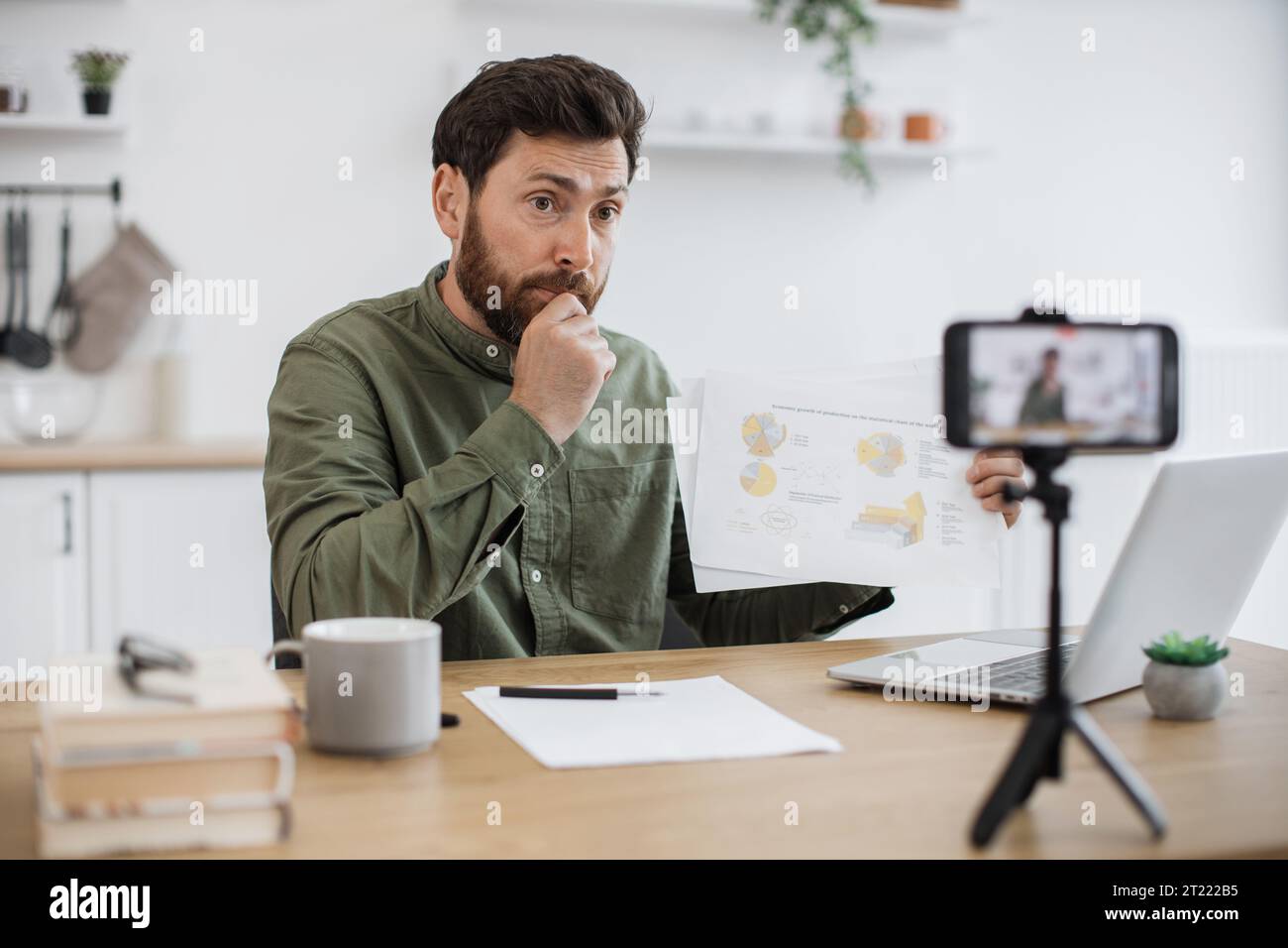 Man explaining graphic charts during video record on mobile Stock Photo ...