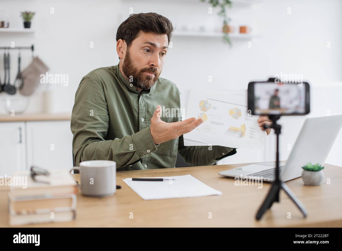 Man explaining graphic charts during video record on mobile Stock Photo ...