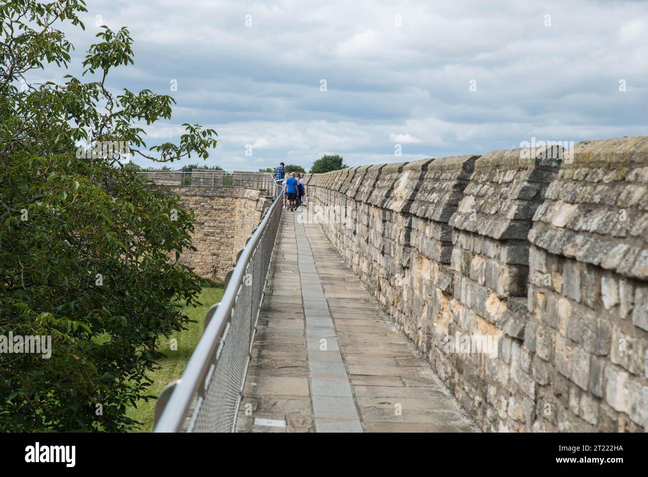 Visitors walking on part of the Medieval Wall Walk at Lincoln Castle ...