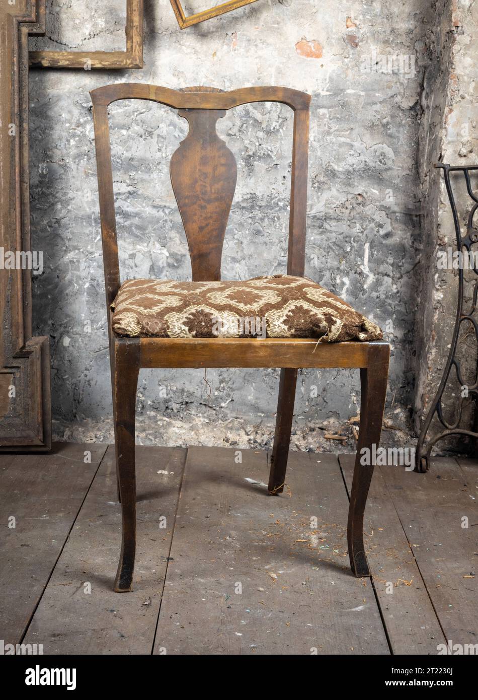 Vintage style . Defective old broken chair in an old dirty room with ...